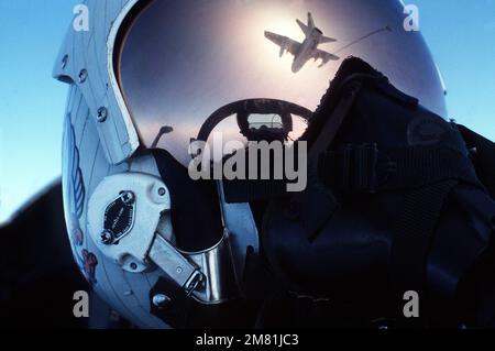 The reflection of an aircraft is visible in the helmet of a pilot from ...