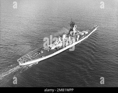 An elevated starboard quarter view of the battleship USS IOWA (BB 61) as it receives ammunition ...