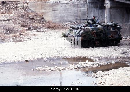 An M113 armored personnel carrier equipped with a .50-caliber machine ...