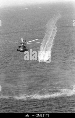 An air-to-air front view of an RH-53D Sea Stallion towing a mine ...