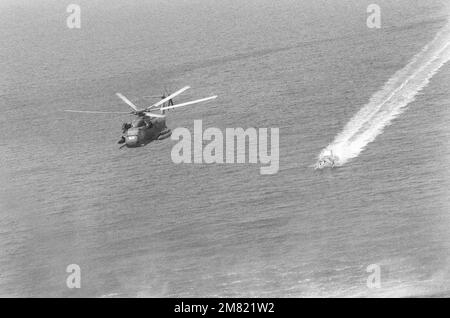 An air-to-air front view of an RH-53D Sea Stallion towing a mine ...