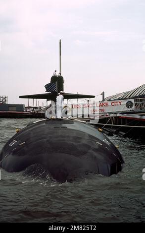 Crew members stand at attention on deck during the commissioning ...