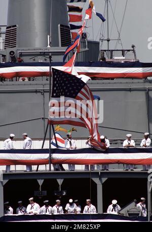 Crewmen line the rails of the nuclear-powered aircraft carrier USS ...