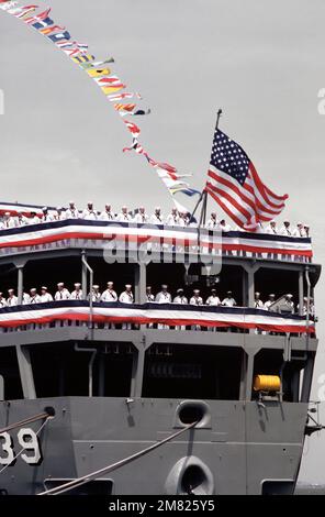 Crewmen line the rails of the nuclear-powered aircraft carrier USS ...