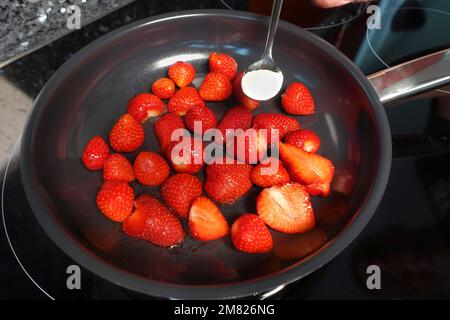 Swabian cuisine, preparation sweet kratzete with flambeed strawberries ...