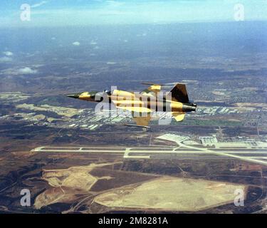 An air-to-air left side view of an F-5 Tiger II aircraft carrying AIM-9 ...