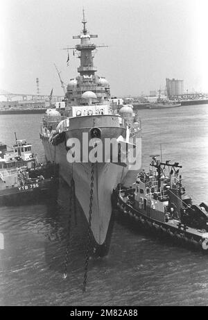 The large harbor tug USS SACO (YTB 796) and two commercial tugs guide ...
