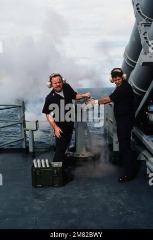 Crewmen aboard the destroyer USS THORN (DD 988) stand along the rail ...