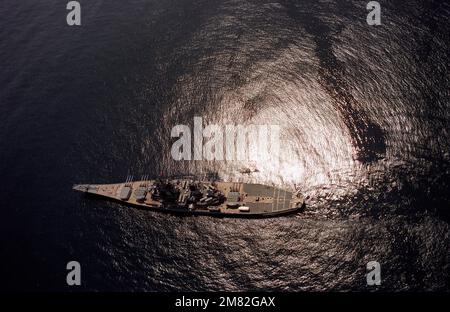 An overhead view of the battleship USS IOWA (BB-61) firing all 15 of ...