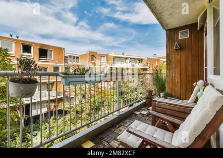 a balcony with chairs and plants on the balkgrounds in melbourne ...