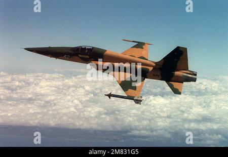 An air-to-air left side view of an F-5 Tiger II aircraft carrying AIM-9 ...