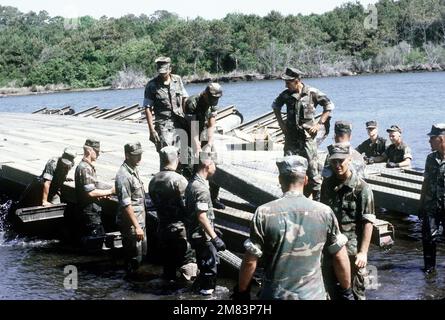 Marines construct a pontoon bridge during exercise Solid Shield '85 ...