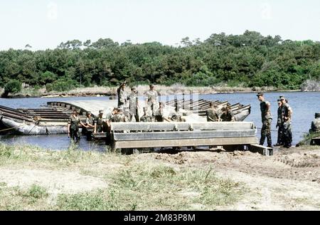 Marines construct a pontoon bridge during exercise Solid Shield '85 ...