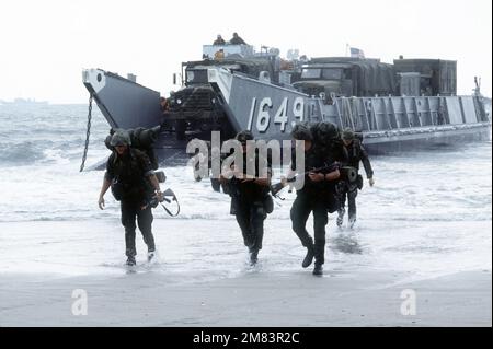 Marines exit from the utility landing craft LCU-1649 at Onslow Beach ...