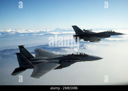 An air-to-air right side view of a 50th Tactical Fighter Wing F-16A ...