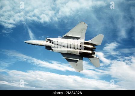An air-to-air underside view of an F-15 Eagle aircraft leading two T-38 ...