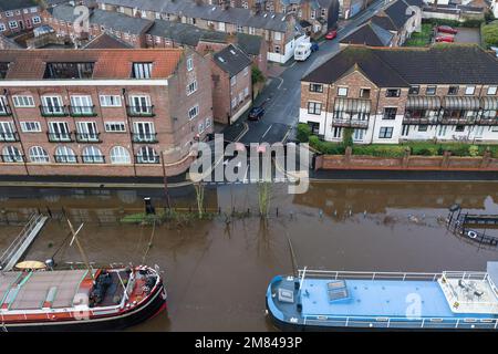 Road flood defences are put in place as heavy rain causes the River ...