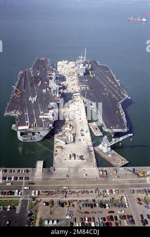 An elevated view of the nuclear-powered aircraft carriers USS NIMITZ (CVN-68), foreground, and ...