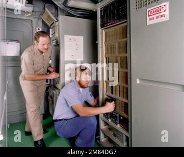 A crewman aboard the guided missile destroyer USS DEWEY (DDG-45 ...