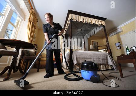 A Housekeeper preparing a hotel room Stock Photo - Alamy