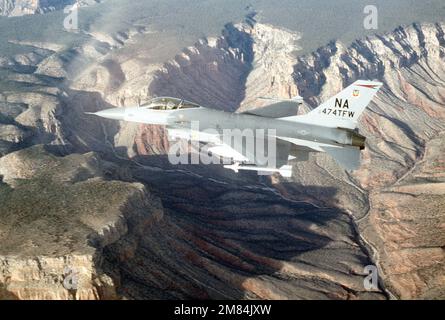 An air-to-air left side view of a 474th Tactical Fighter Wing (474th ...