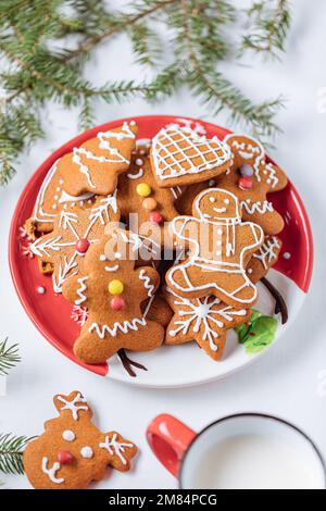 Gingerbread house decorated with white royal icing and bright candies ...