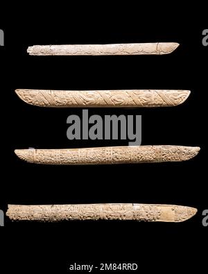 Bone with carved figures used for ritual purposes. Museum of Cultures ...