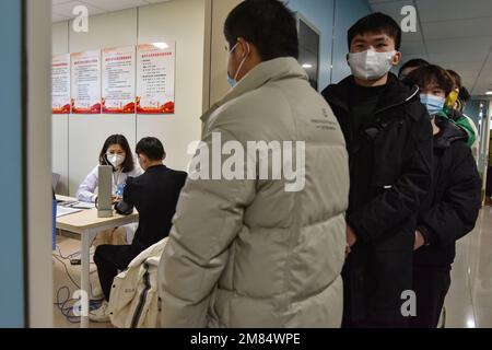 Fuyang, China. 12th Jan, 2023. Young men line up with their physical ...