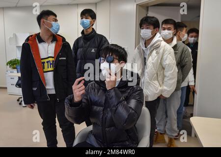Fuyang, China. 12th Jan, 2023. Young men line up with their physical ...