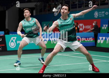 Malaysia's Aaron Chia, right, and Soh Wooi Yik celebrate on the podium with their gold medals ...