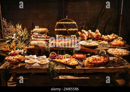 A wooden table with a variety of sweets and dishes Stock Photo - Alamy