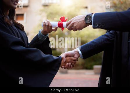 Shaking hands, graduation and certificate for college student with ...