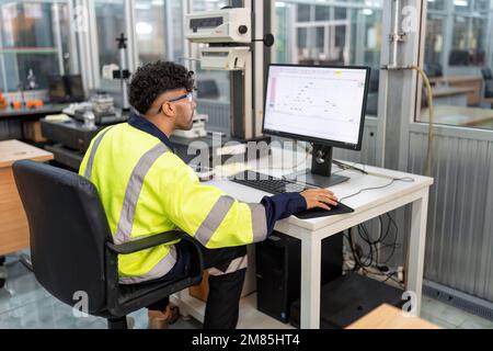 Engineer sitting in robot electronic room use computer create process ...
