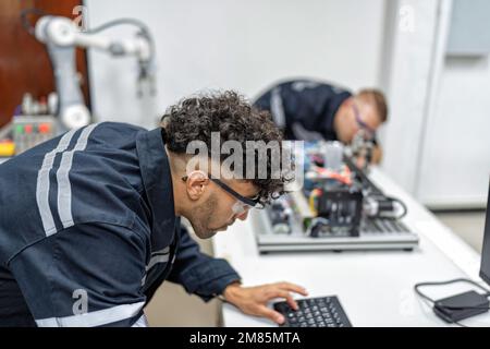 Engineer stand in robot fabrication room quality checking electronic ...
