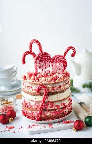 Christmas many layers cake decorated with lolli pops, red and white ...