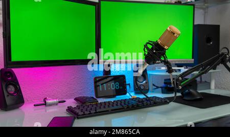 workstation with microphone and monitors with green screen for montage ...