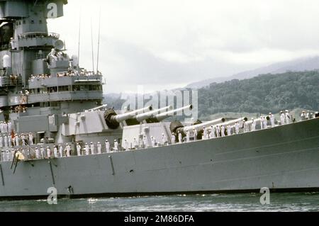 Crew members aboard the battleship USS MISSOURI (BB 63) give a cheer to ...