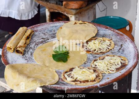 Tlayudas (big roasted tortillas) at a street food stall in Oaxaca city ...