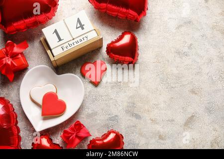 Tasty heart shaped cookies, calendar with date 14 FEBRUARY and gift on ...