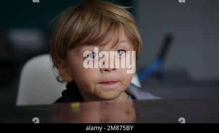 Baby toddler hypnotized by screen, kid biting table while watching ...