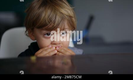 Baby toddler hypnotized by screen, kid biting table while watching ...