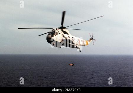 An air-to-air left front view of an SH-3 Sea King helicopter from Fleet ...