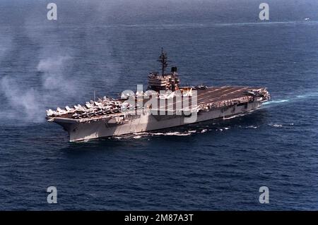A port bow view of the USS KITTY HAWK (CV-63) as crewmen form the ...