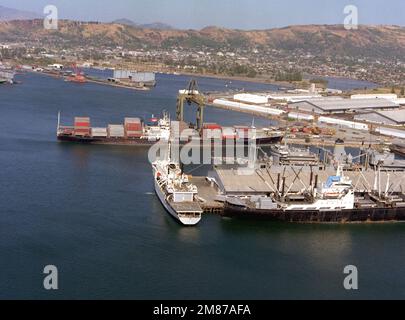 An aerial view of four Military Sealift Command ships moored at the ...