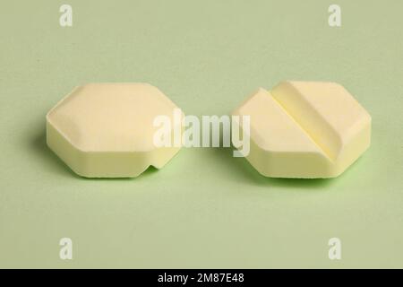 Hexagonal pills on light green background. Extreme closeup. High ...