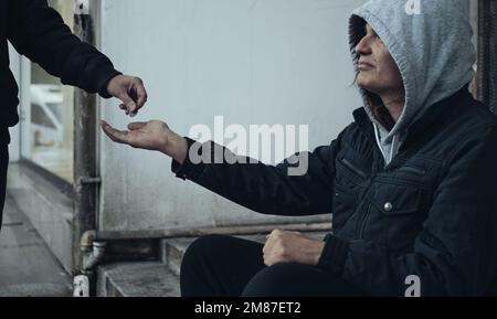 Stressed hungry homeless man sitting on city street waiting for help ...