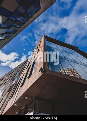 Vertical low angle shot of modern glass business buildings touching the ...