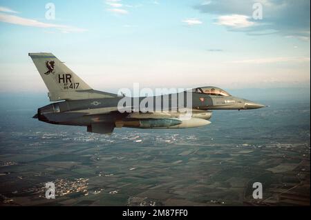 An air-to-air right side view of a 50th Tactical Fighter Wing F-16A ...