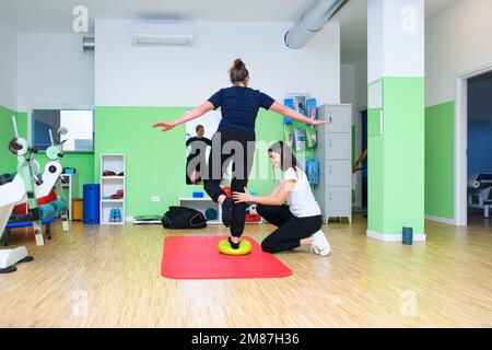A physiotherapist has a patient perform exercises for ankle ...