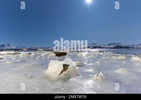 Frozen salt water under full moon, night in the Arctic in freezing ...